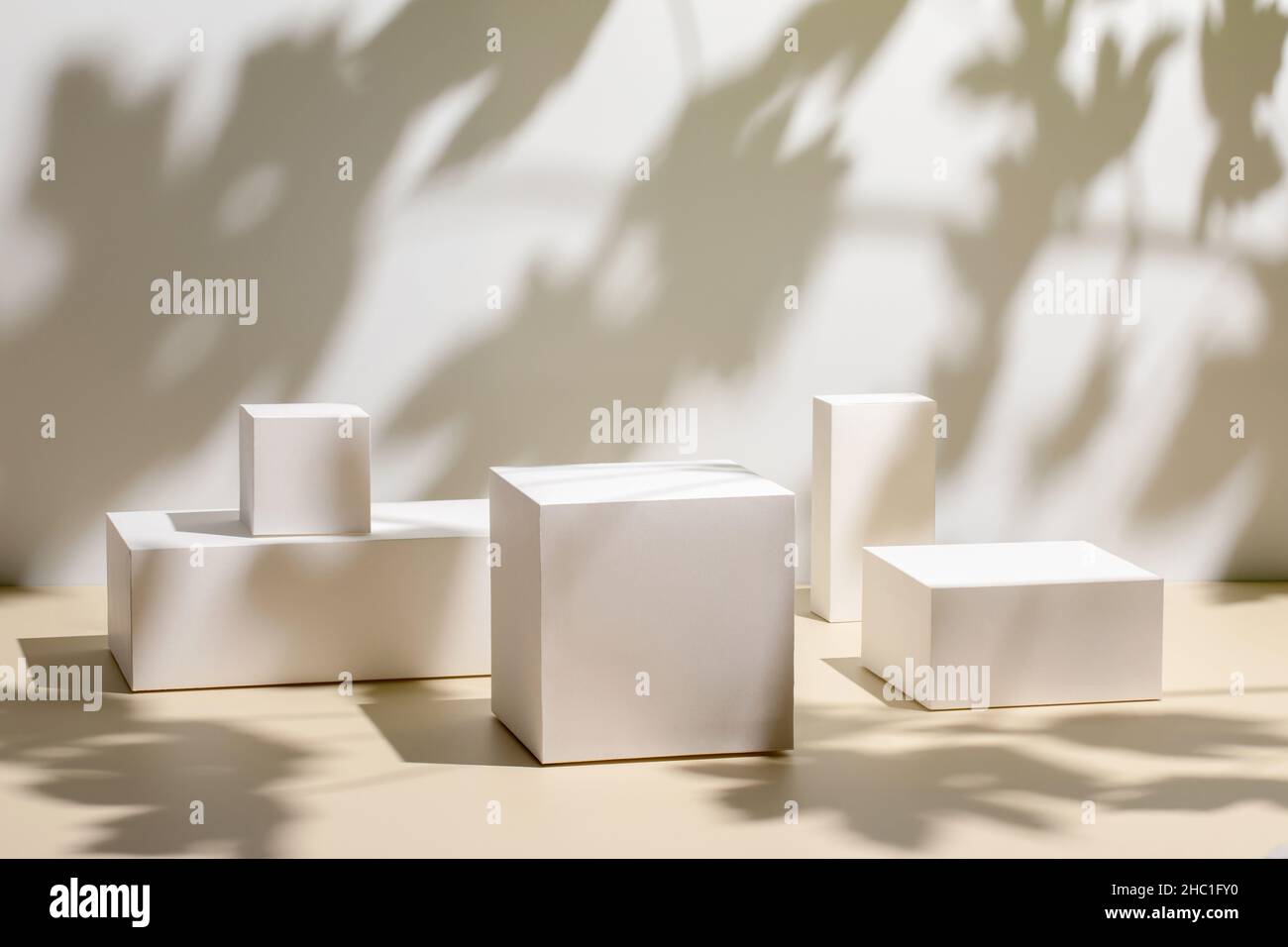 scene with five white podiums on beige background Stock Photo - Alamy