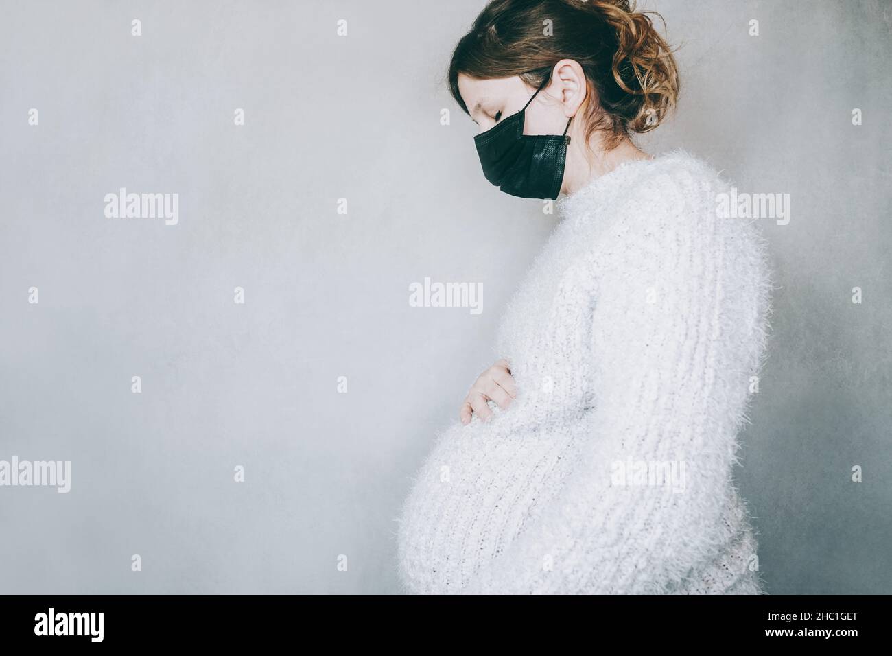 Young pregnant woman wearing a mask during covid 19 pandemic Stock ...