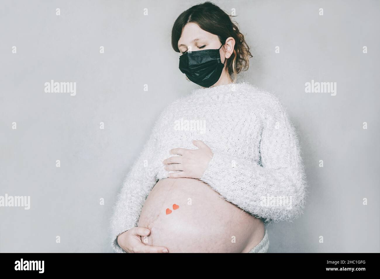Young pregnant woman wearing a mask during covid 19 pandemic Stock ...