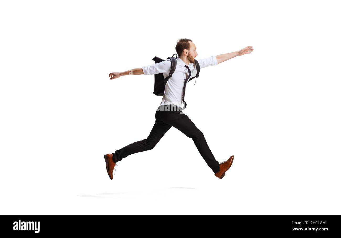 Full-length portrait of young man hurrying up to work isolated over ...