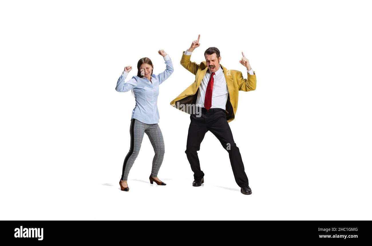 Full-length portrait of two cheerful workers dancing due to end of ...