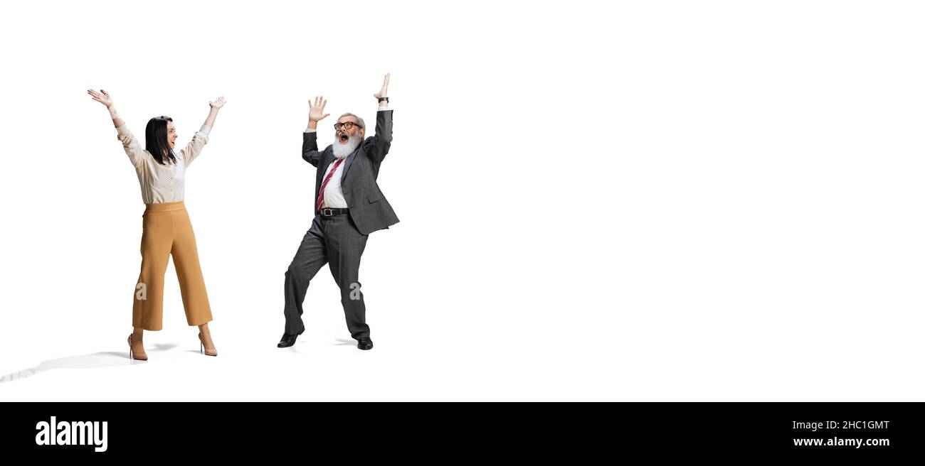 Full-length portrait of two happy and excited employee celebrating ...