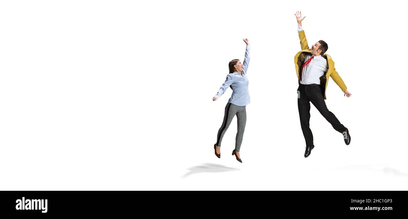 Full-length portrait of two excited worker jumping isolated over white ...