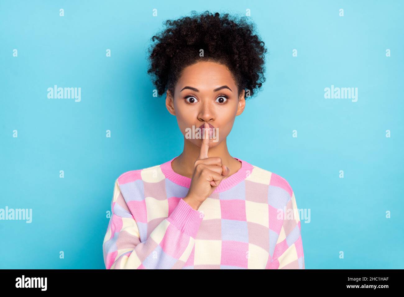 Portrait of attractive mysterious wavy-haired girl showing shh sign ...