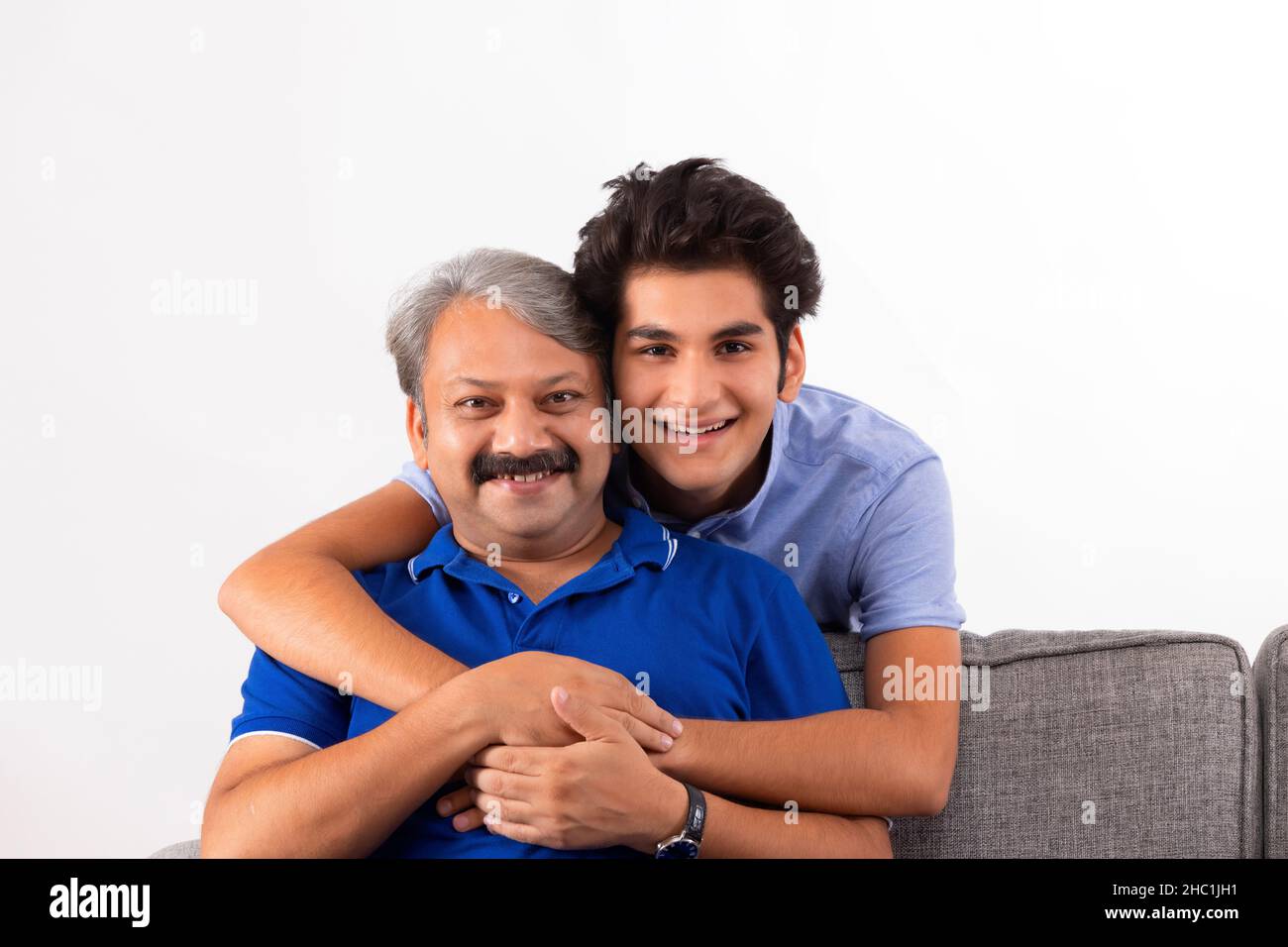 Indian father and son posing together with smiling face in front of ...