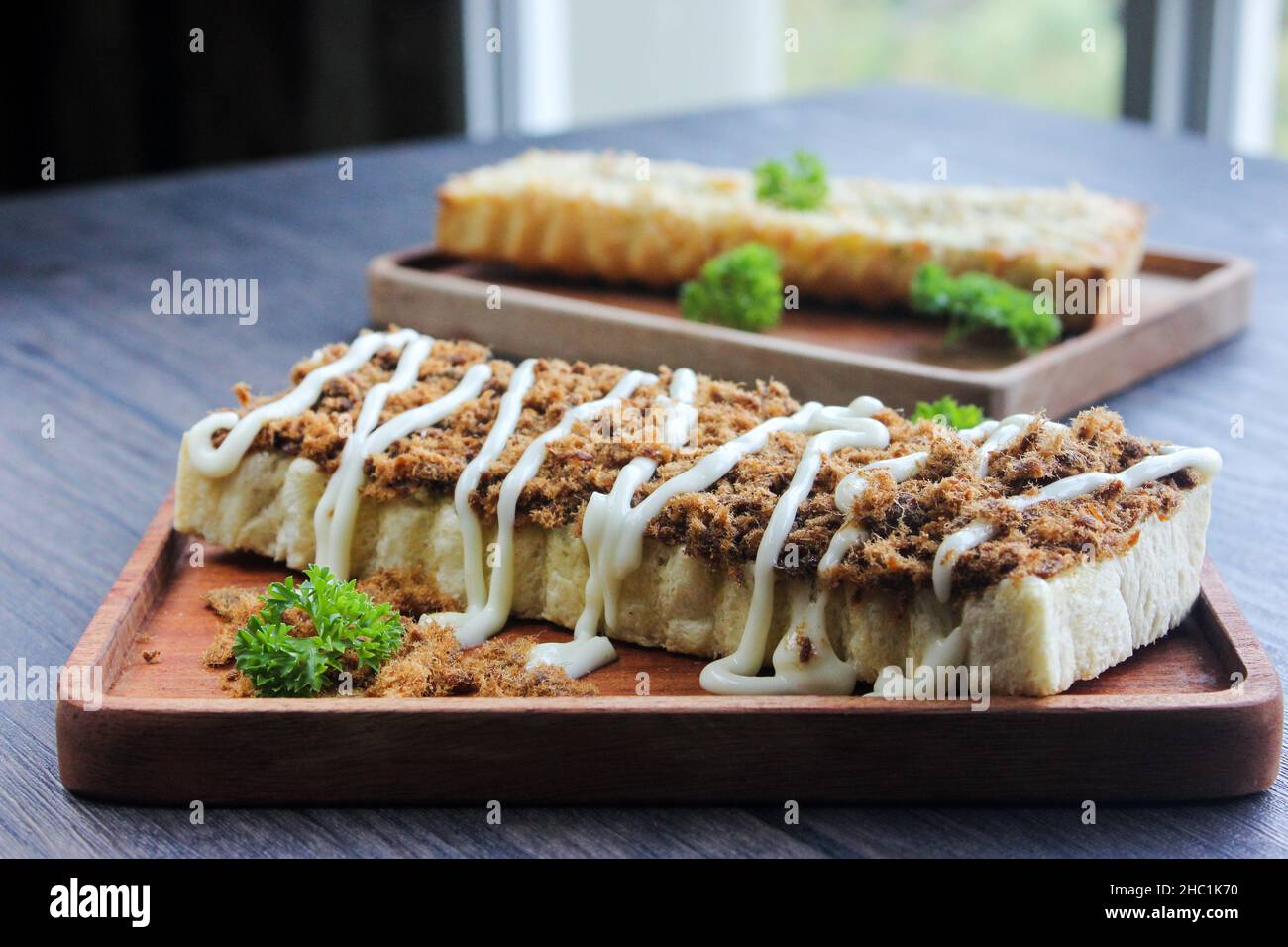 Side view Toast with shredded beef topped with mayonnaise. Served on ...