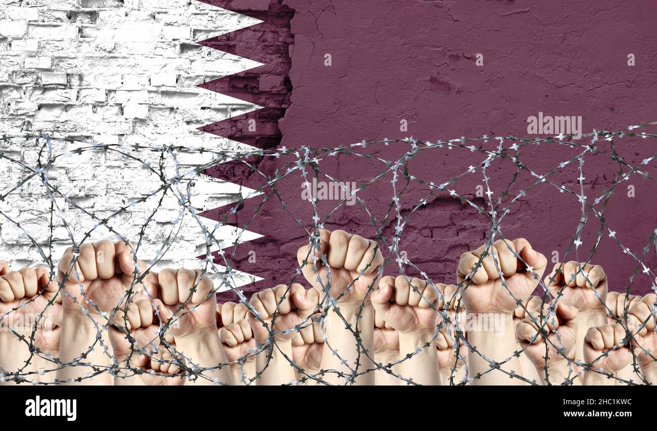 Barbed wire against the background of the inflicted flag of Qatar and ...
