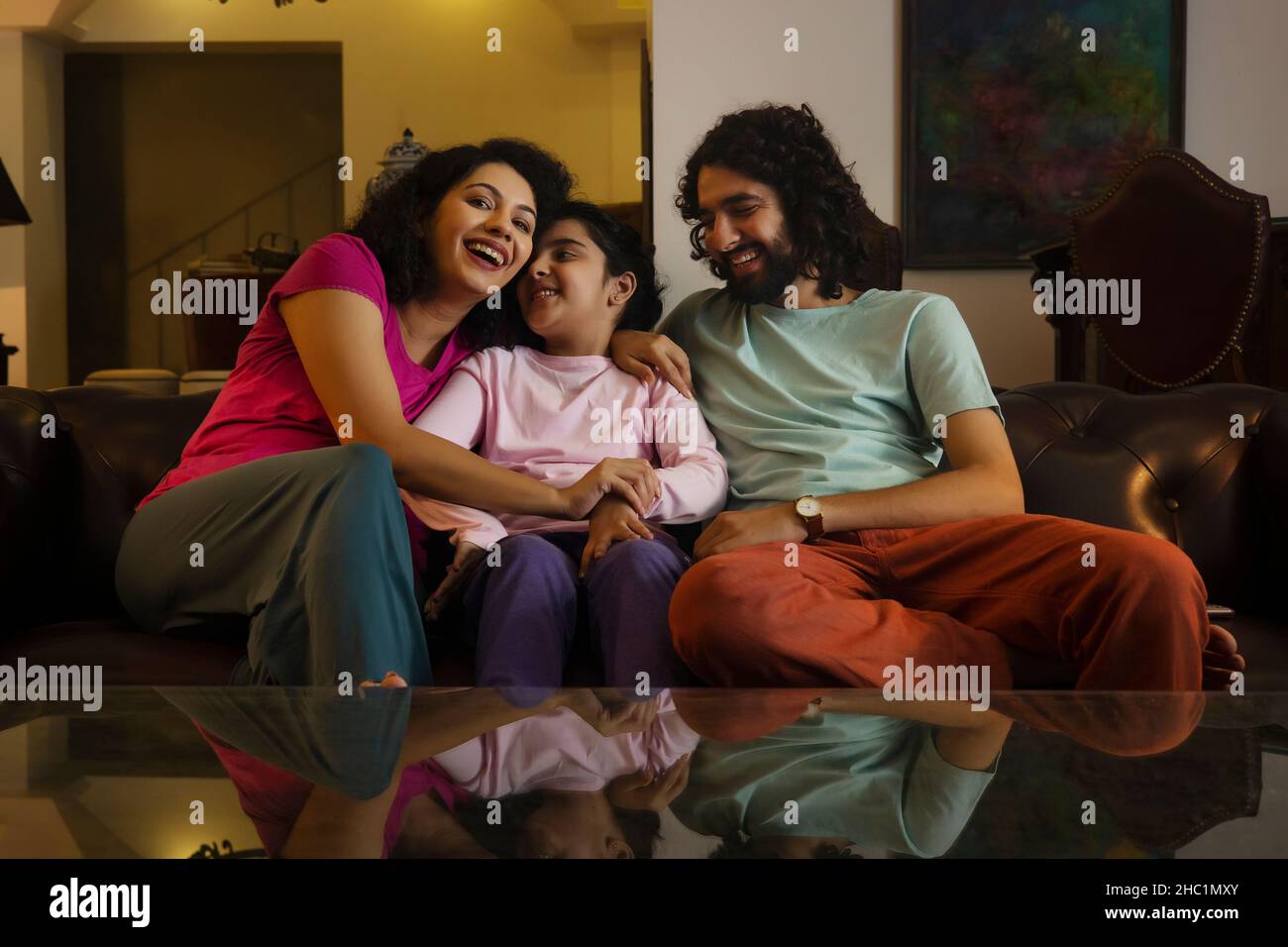 Family members sharing an intimate moment in living room at night Stock ...