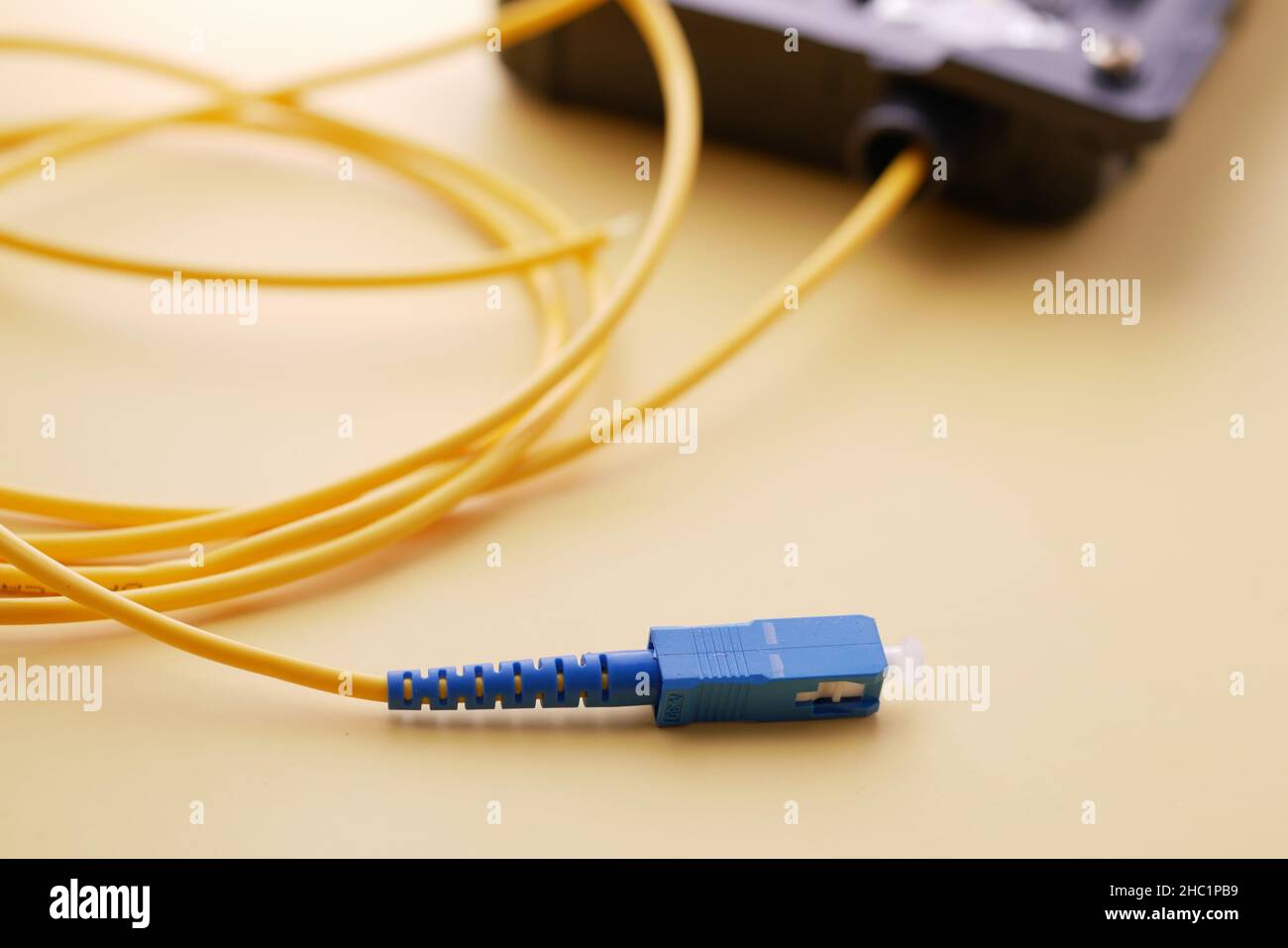 Wi-Fi router with cables on yellow background Stock Photo - Alamy