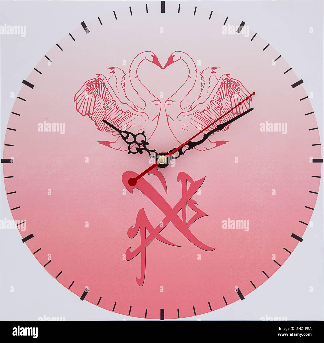 Wall clock pink on a light background Stock Photo - Alamy