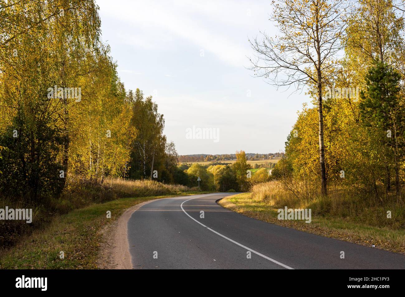 A two-lane road passing through a picturesque area. A sharp right turn ...