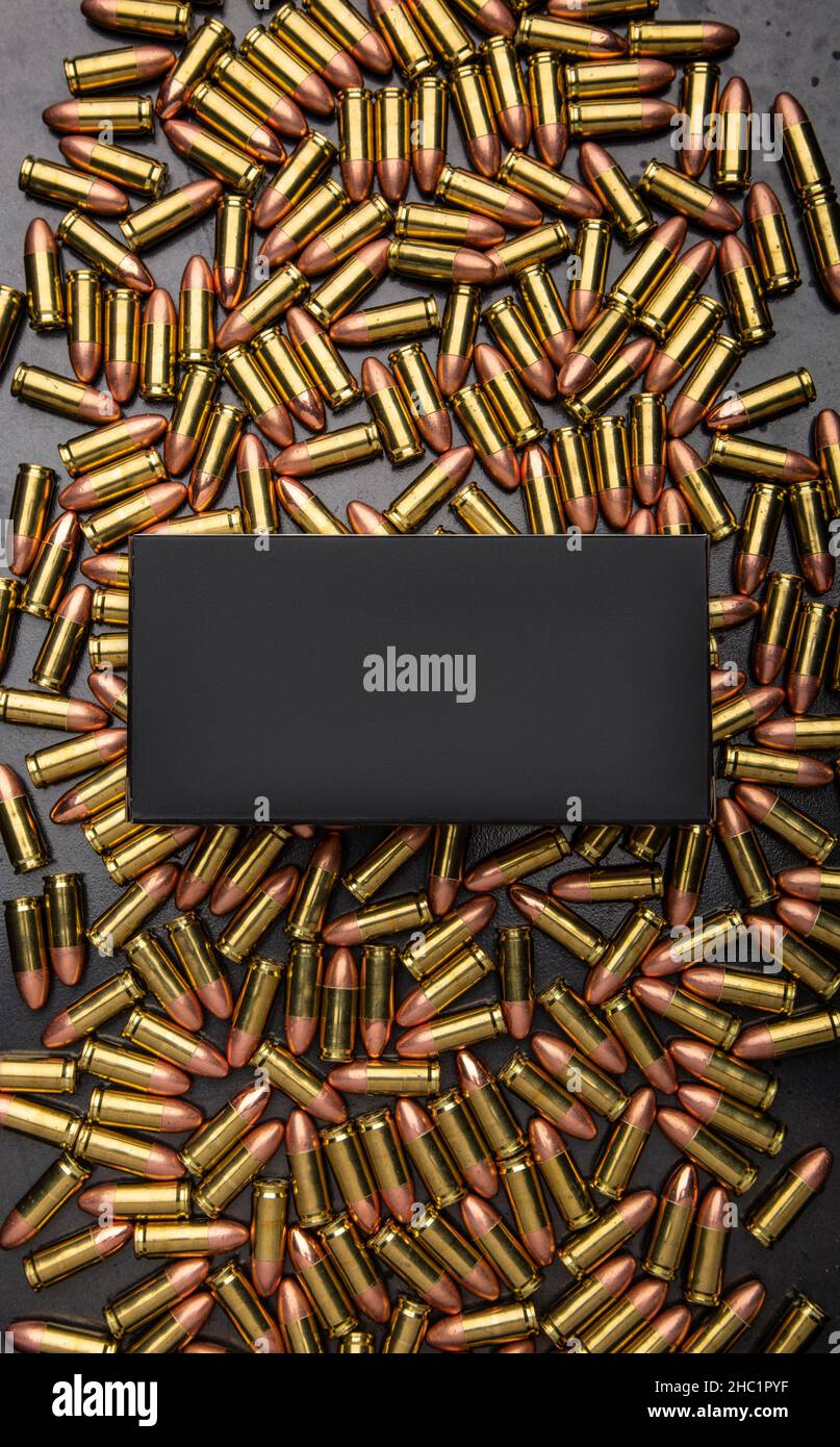 Pistol cartridges on a dark background. Ammunition for weapons. Box of ...
