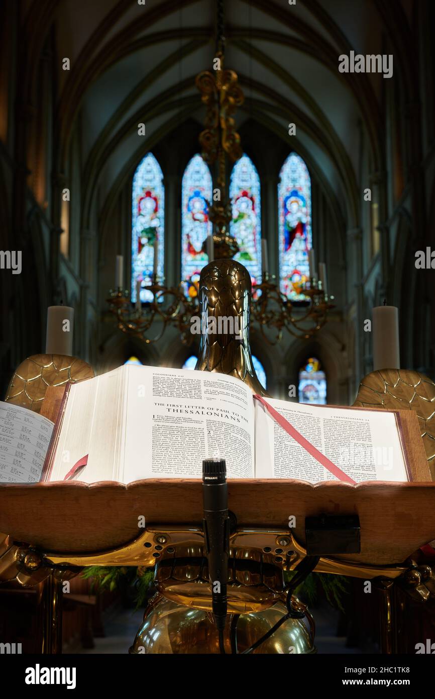 Open page of the Bible on a lectern in the choir of the church at ...