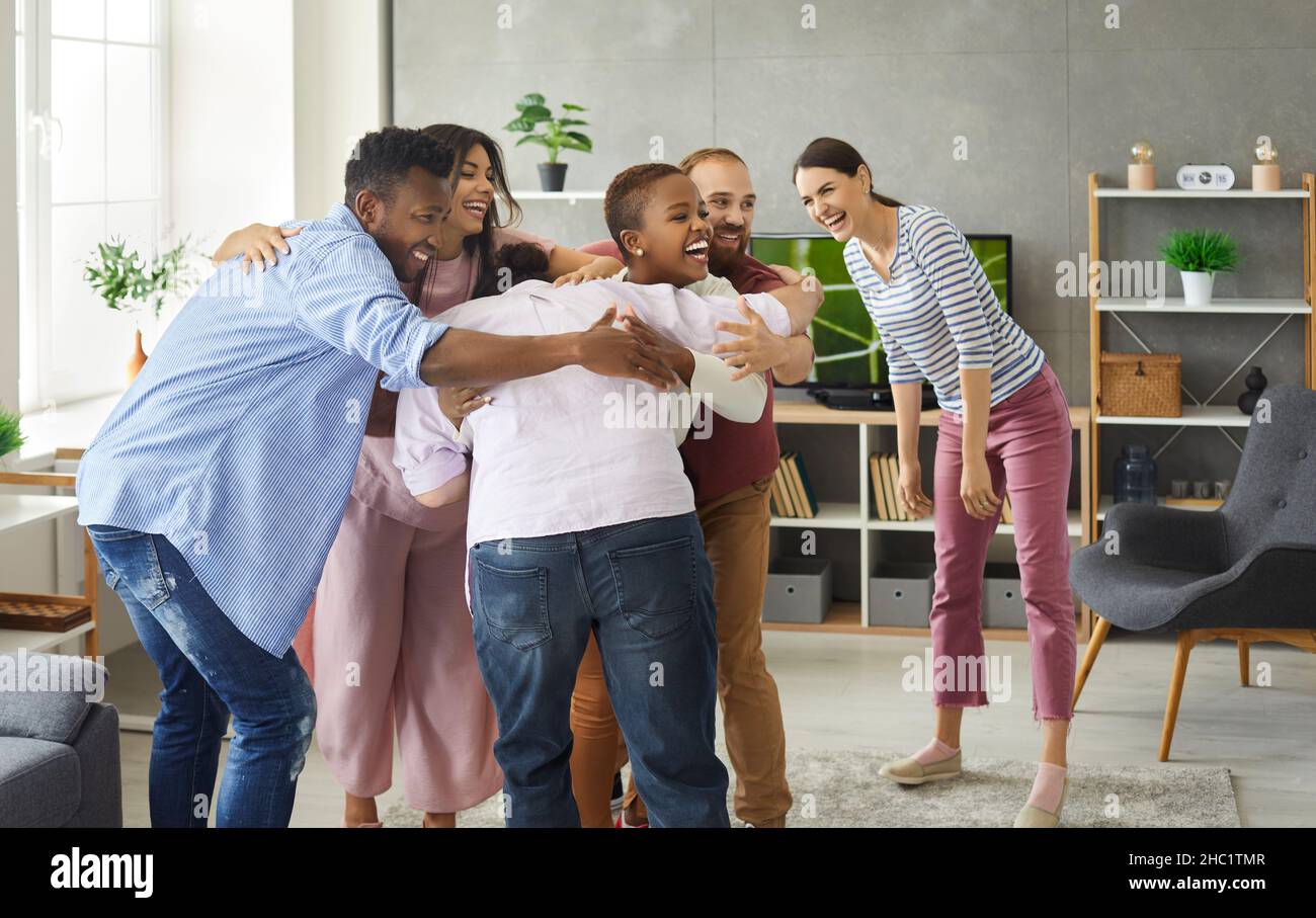 Group Of Happy Excited Young Multiracial Friends Having Fun And Hugging
