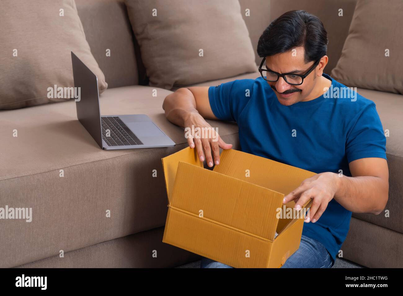 Man unpacking parcel home hi-res stock photography and images - Alamy