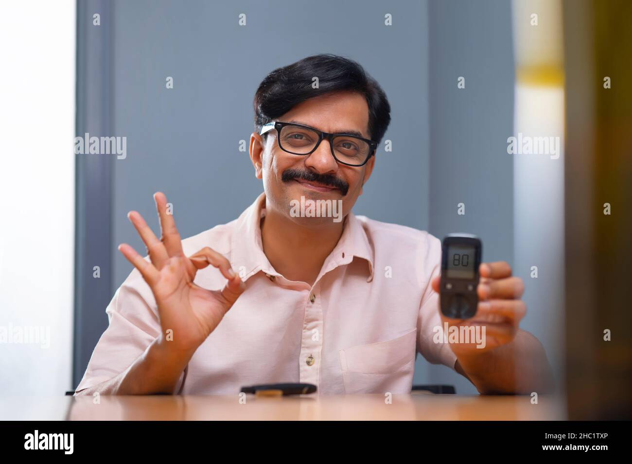 Man in relax mood while blood sugar level is showing normal on ...