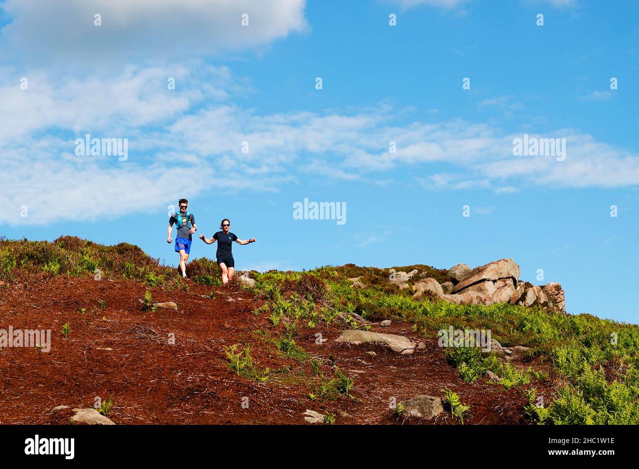 Fell runners making their way down Embsay Crag on a fine summers day ...
