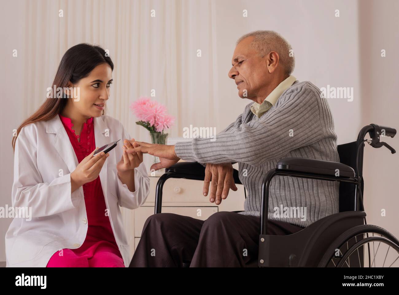 Nurse checking blood sugar of an old man Stock Photo - Alamy