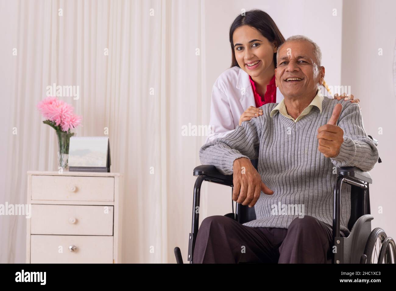 Nurse moving senior man sitting on wheel chair Stock Photo - Alamy