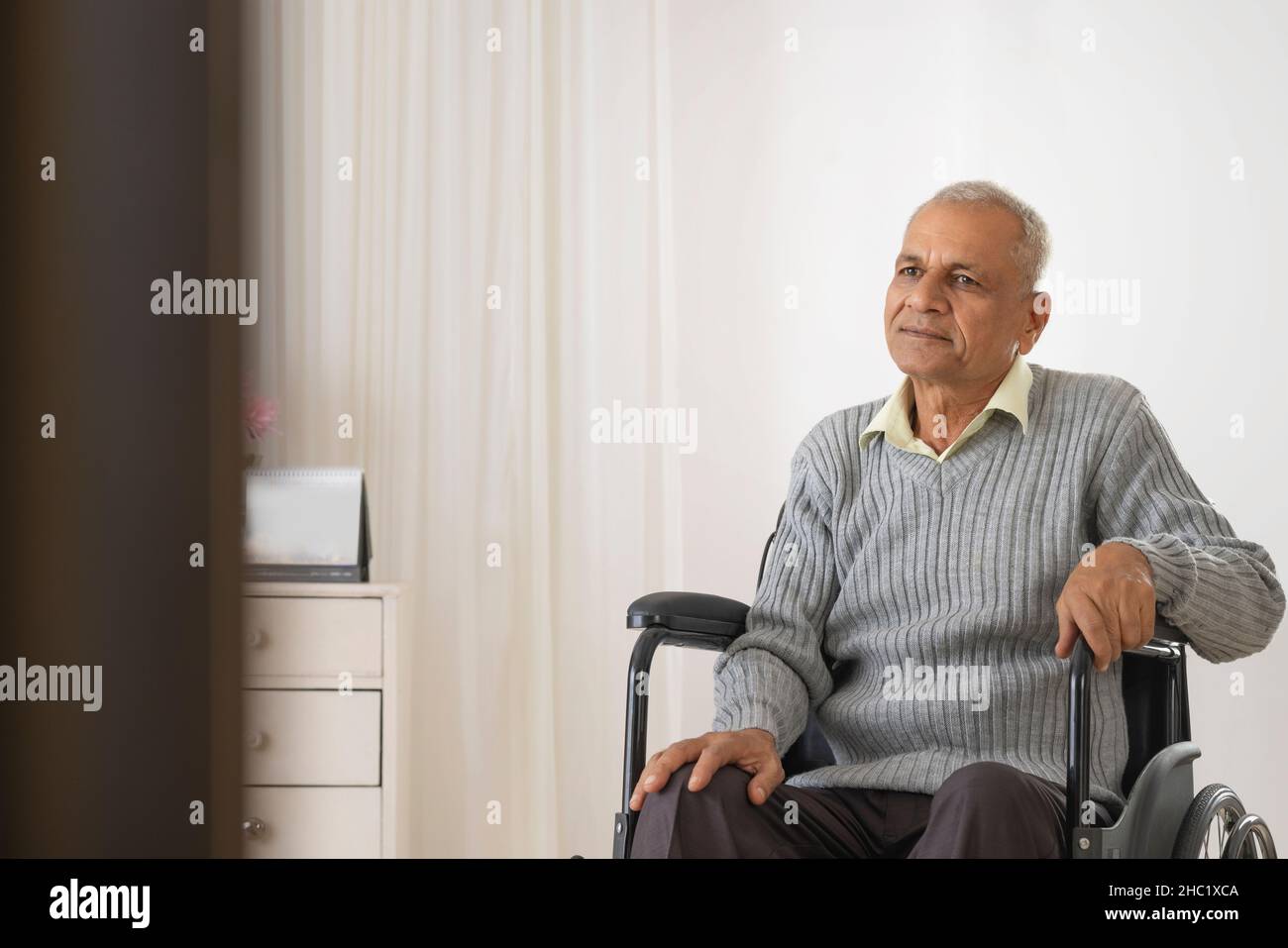 Sick old man sitting on wheel chair alone Stock Photo - Alamy