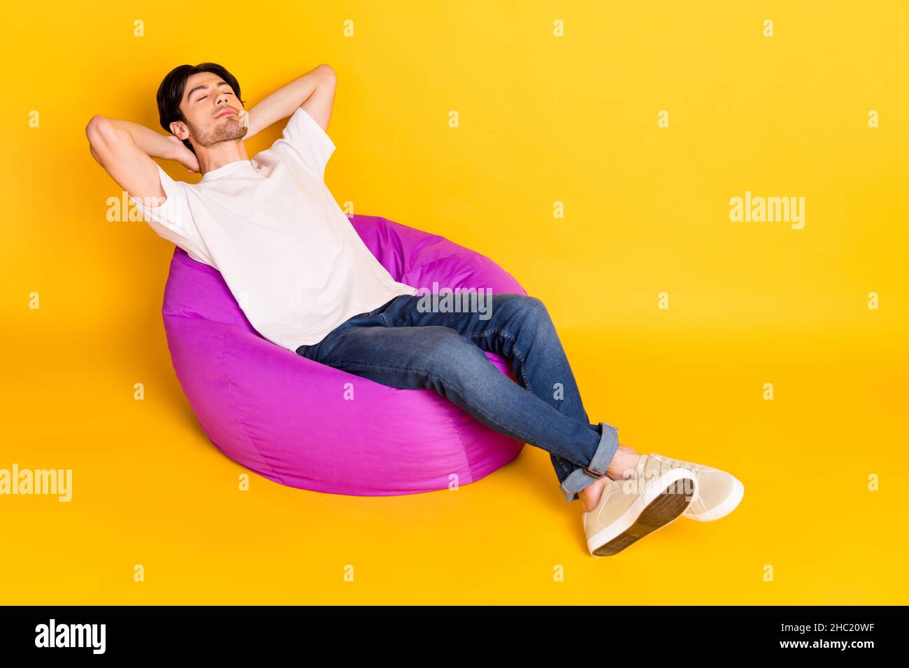 Portrait of attractive dreamy calm guy lying in chair resting free time ...