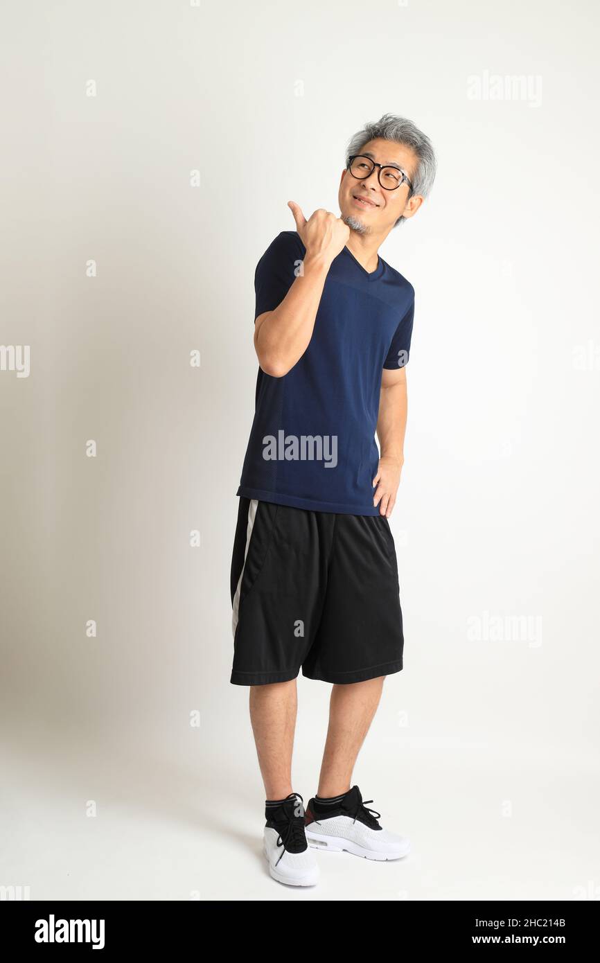 The Asian senior man with sport clothes on the white background Stock ...