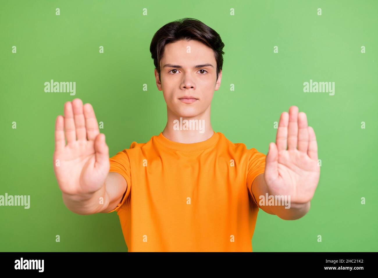 Photo of young serious man hold hands stop sign prohibition gesture ...