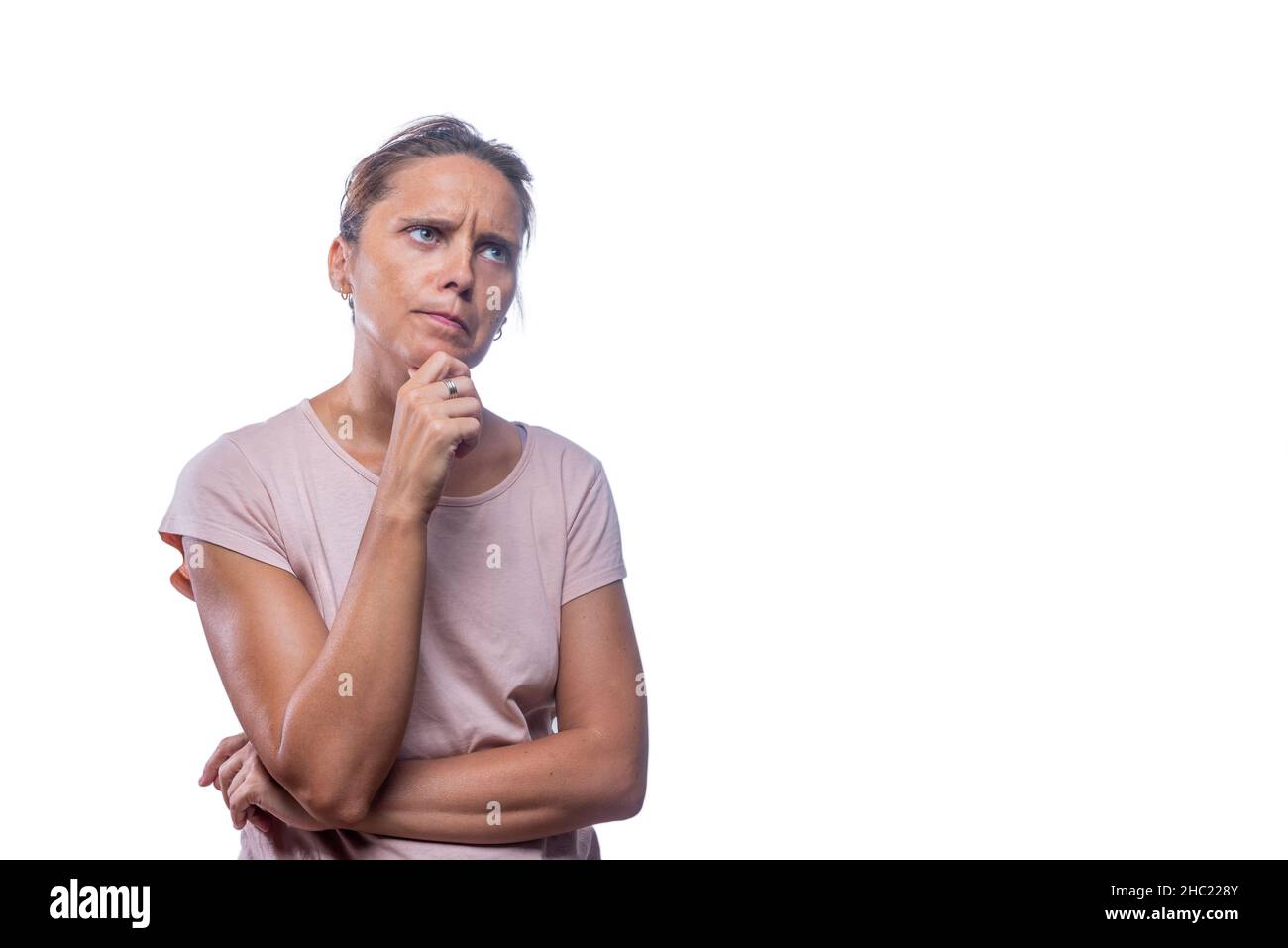 A thoughtful and concerned woman on a white background Stock Photo - Alamy