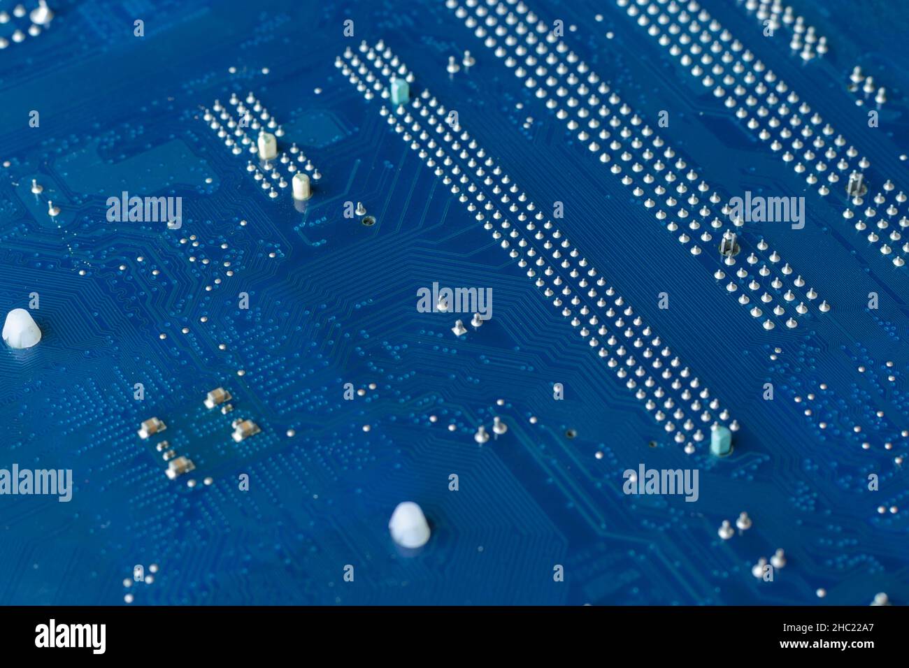 Defocused blue computer motherboard closeup background. Selective focus ...