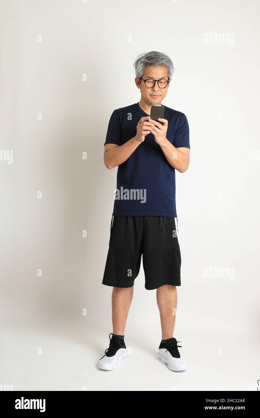 The Asian senior man with sport clothes on the white background Stock ...