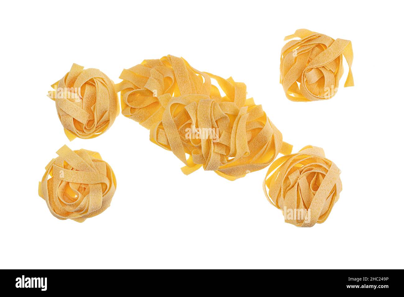 Uncooked tagliatelle nests pasta Stock Photo - Alamy