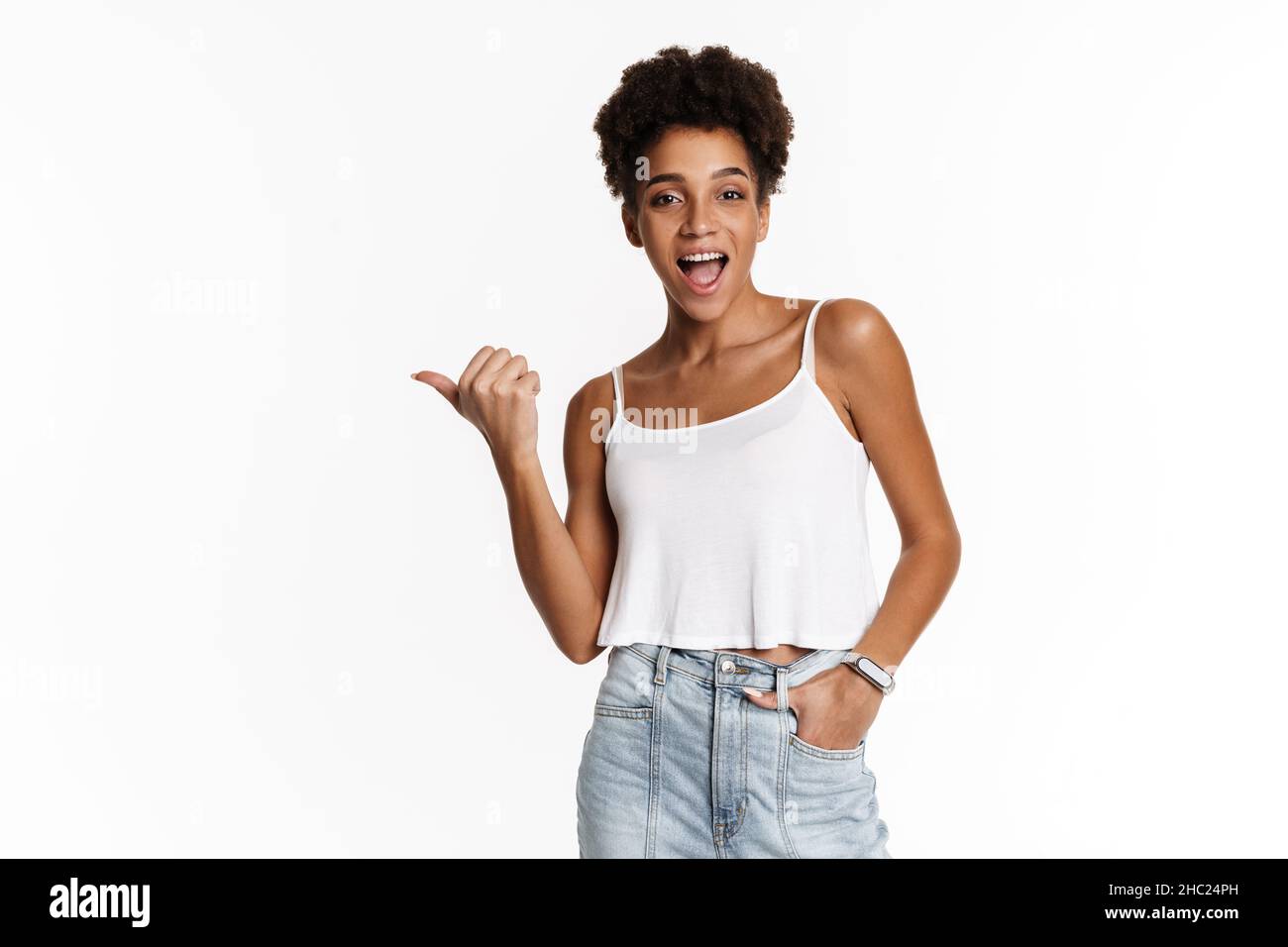 Young black woman in tank top laughing and pointing finger aside ...