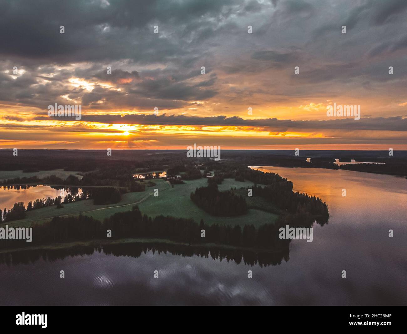 Sunset view of beautiful and rural lake scene. Sun glowing on lake ...