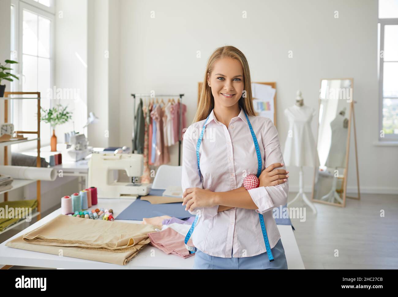 Portrait of smiling woman seamstress pose in atelier Stock Photo - Alamy
