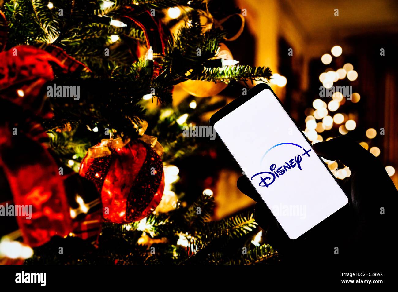 In this photo illustration a Disney Plus logo seen displayed on a ...