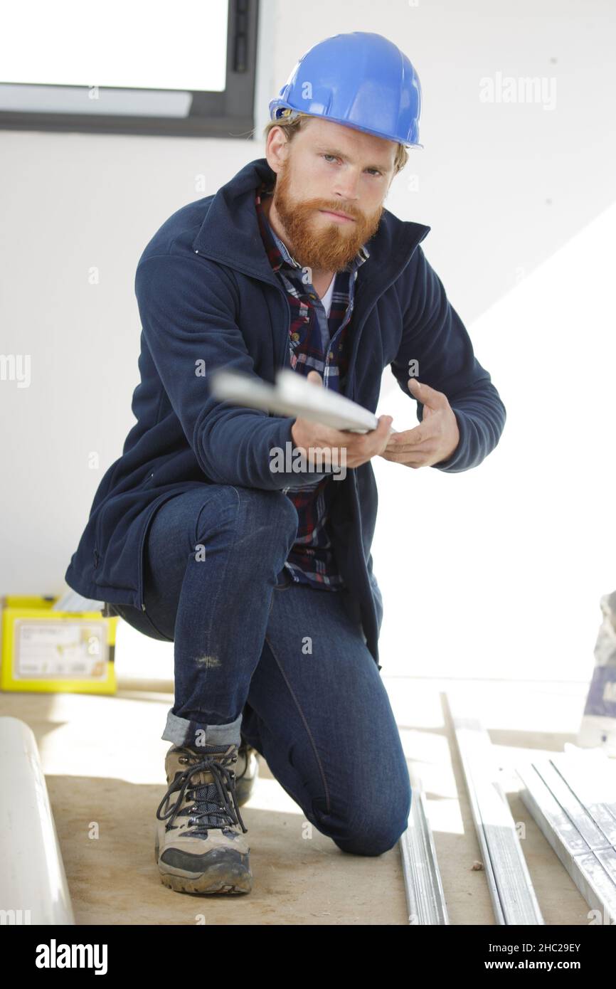 concentrated man builder holding a frame Stock Photo - Alamy