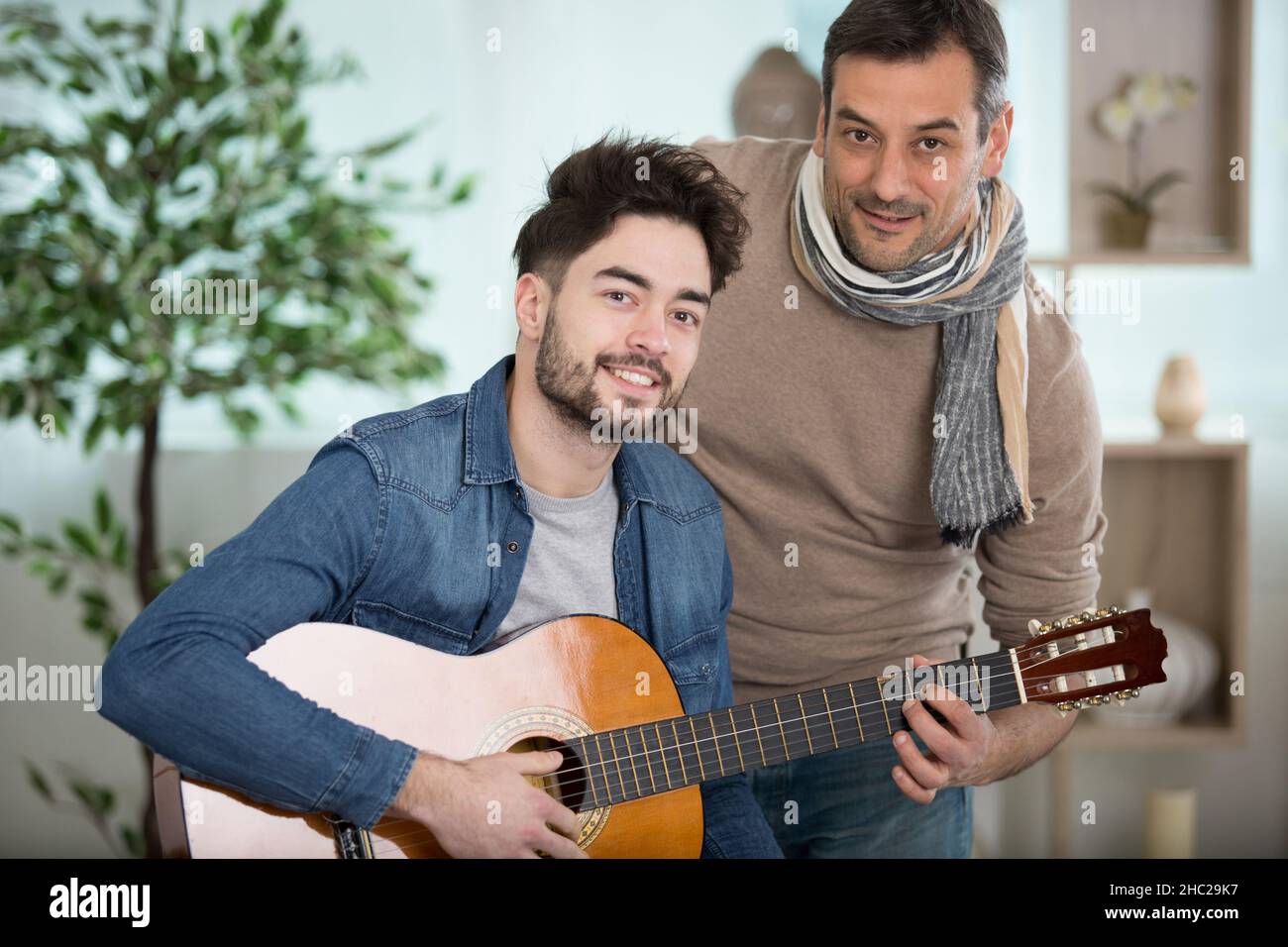 people with acoustic guitar girl touching strings learning chords Stock ...