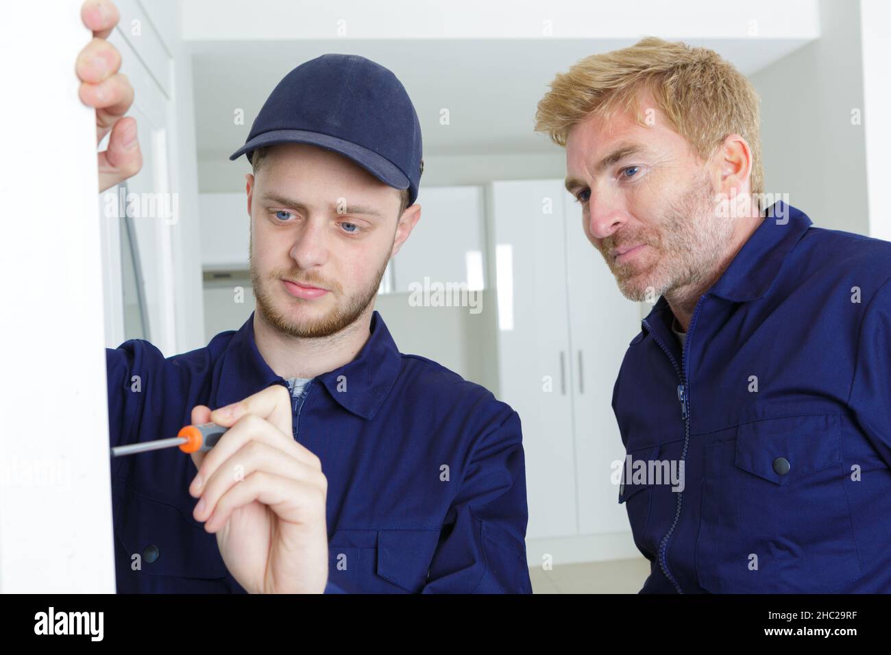 electrician and apprentice working together Stock Photo - Alamy