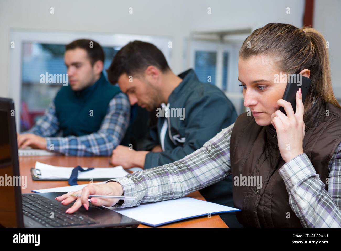 female worker on the phone in a warehouse office Stock Photo - Alamy