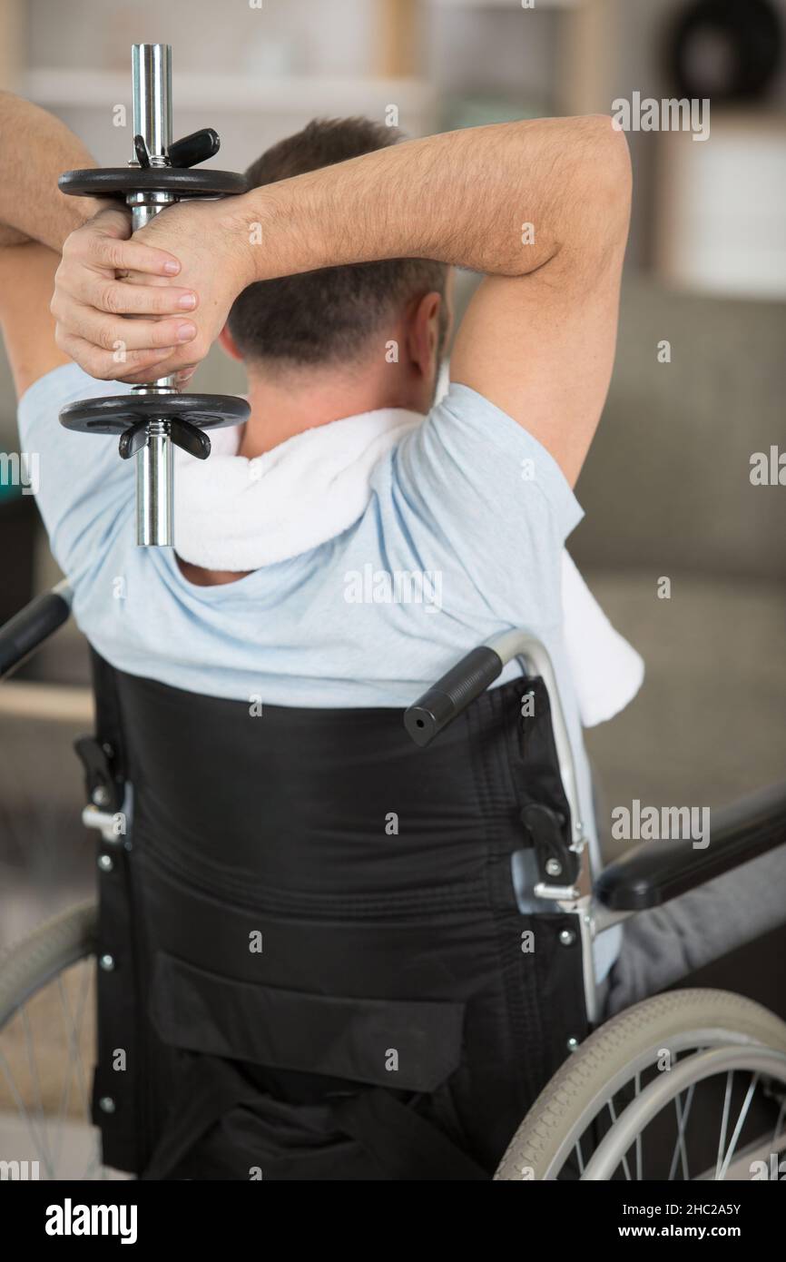handicapped man on wheelchair working out with dumbbell Stock Photo - Alamy