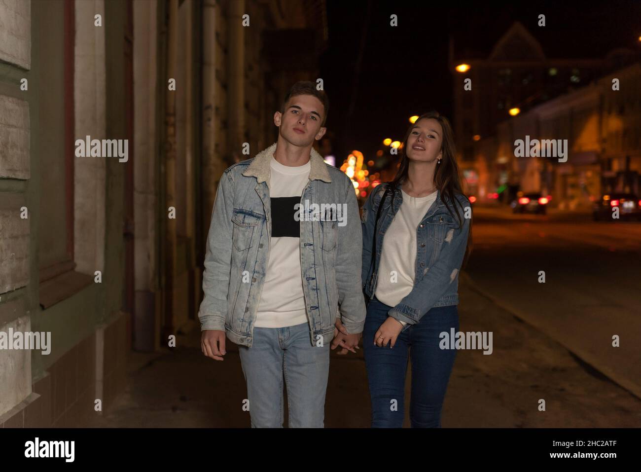 Beautiful young couple walking on the street. Young couple on an ...