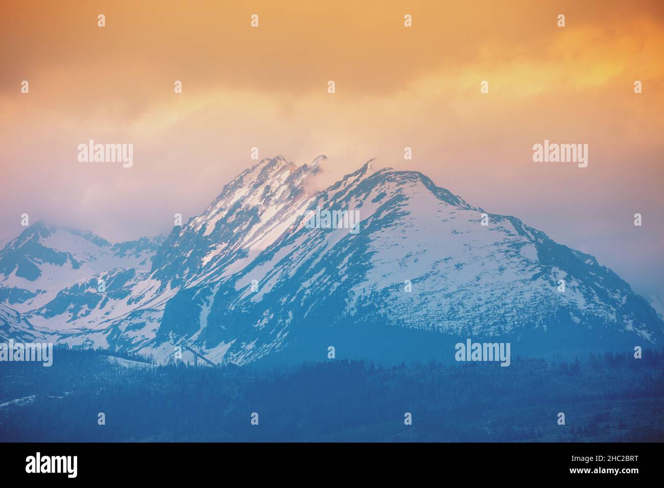 Beautiful snow-capped mountains against the backdrop of a sunset sky ...