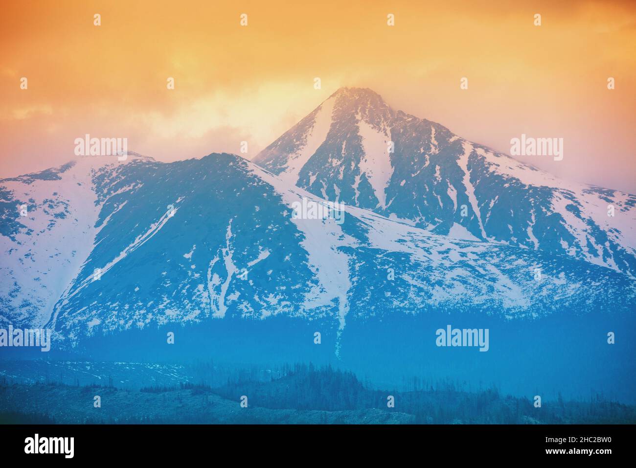 Beautiful snow-capped mountains against the backdrop of a sunset sky ...