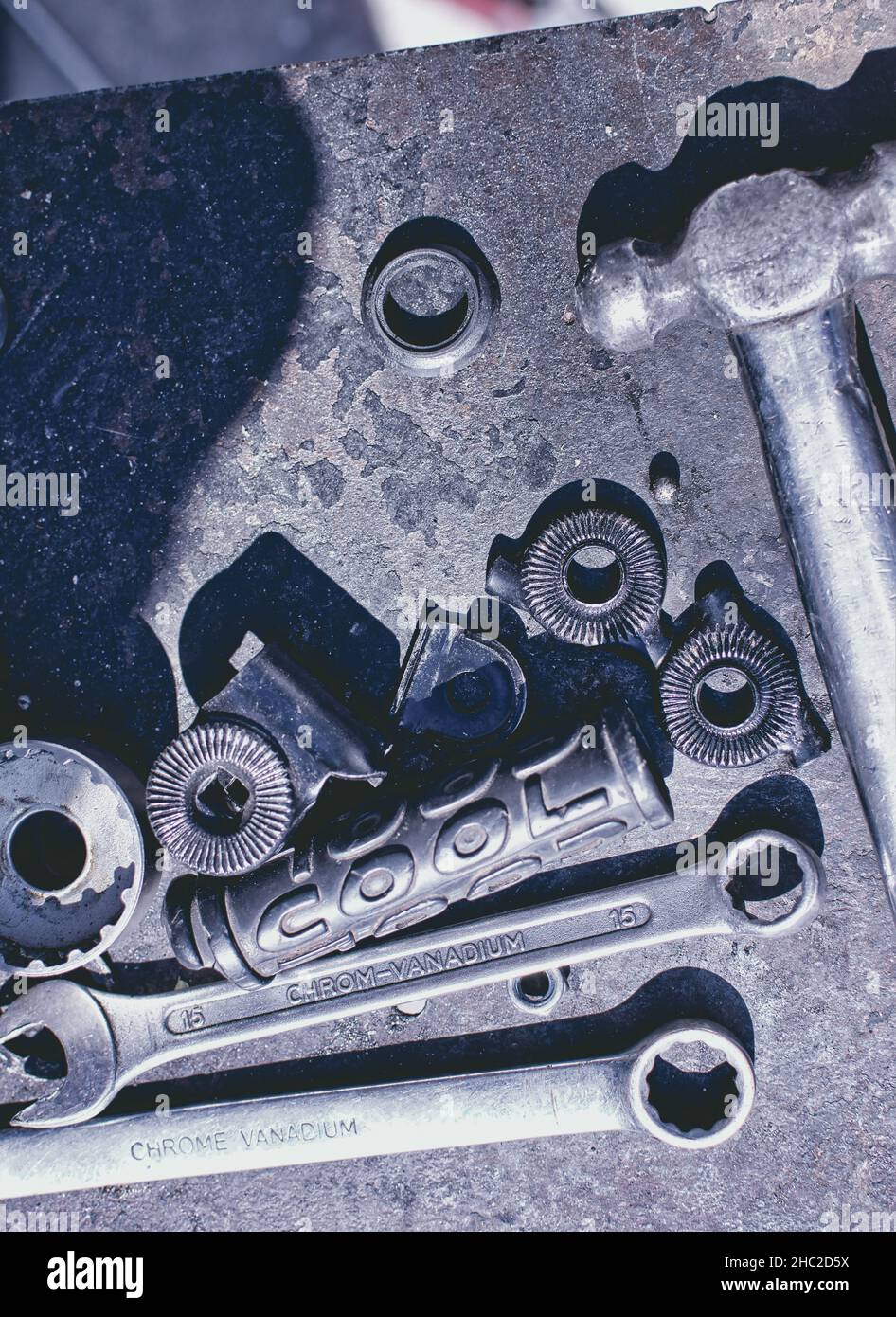 Bicycle mechanic tools set on the table: handlebar grip, bolts, hammer ...