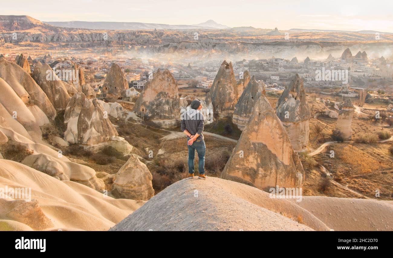 Thinking man with crossed hands over back is admiring morning views of ...