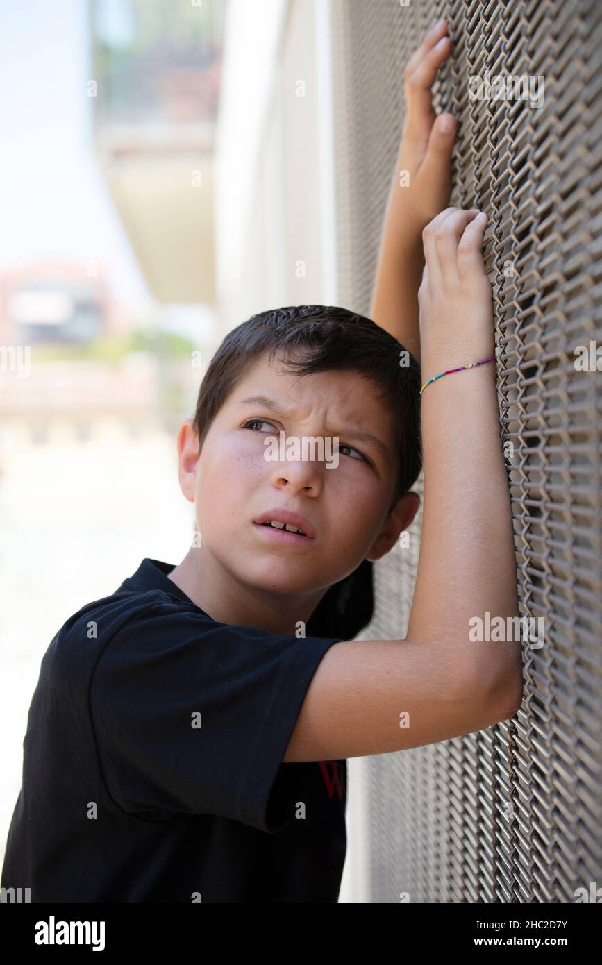 Portrait of handsome male child in the city outdoors. Natural light ...