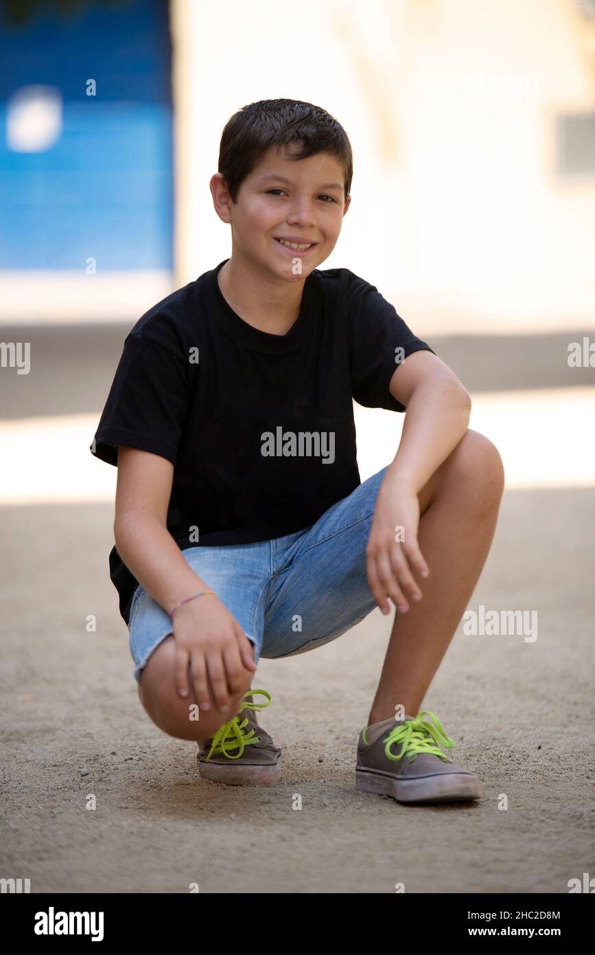 Portrait of handsome male child in the city outdoors. Natural light ...