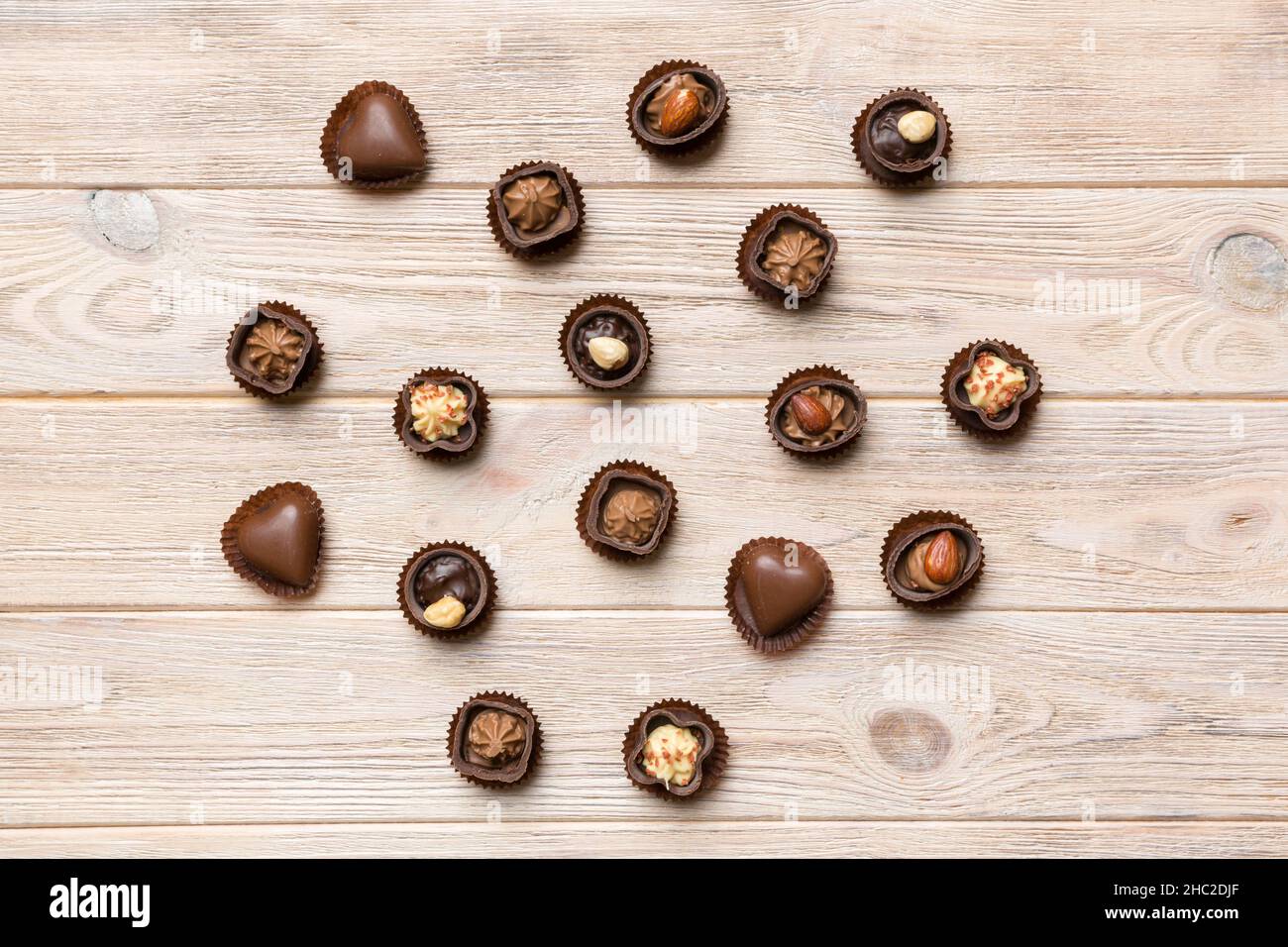 Different kinds of chocolates on colored table close-up. Top View and ...