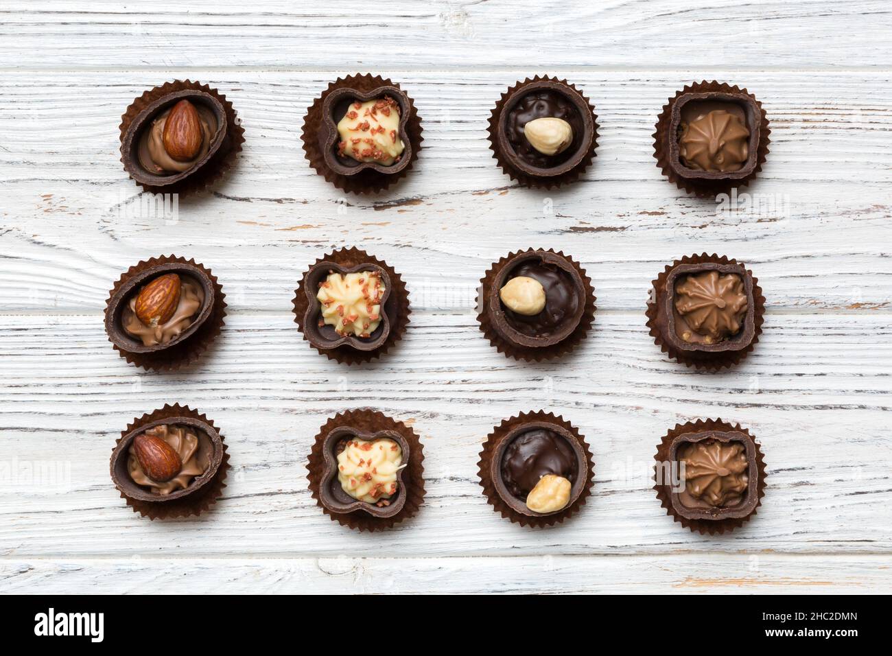 Different kinds of chocolates on colored table close-up. Top View and ...