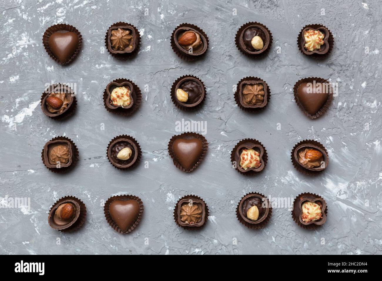 Different kinds of chocolates on colored table close-up. Top View and ...